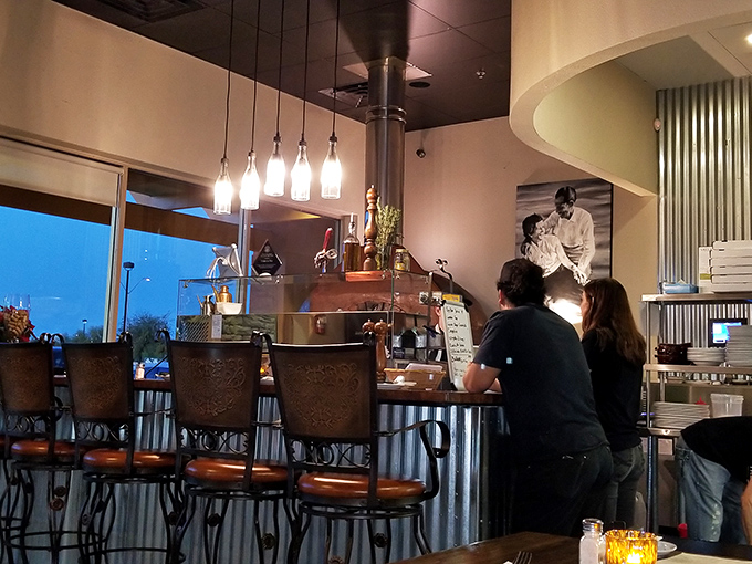 The counter seating offers front-row tickets to the culinary show. Watch pizza artistry happen before your eyes—better than any theater.