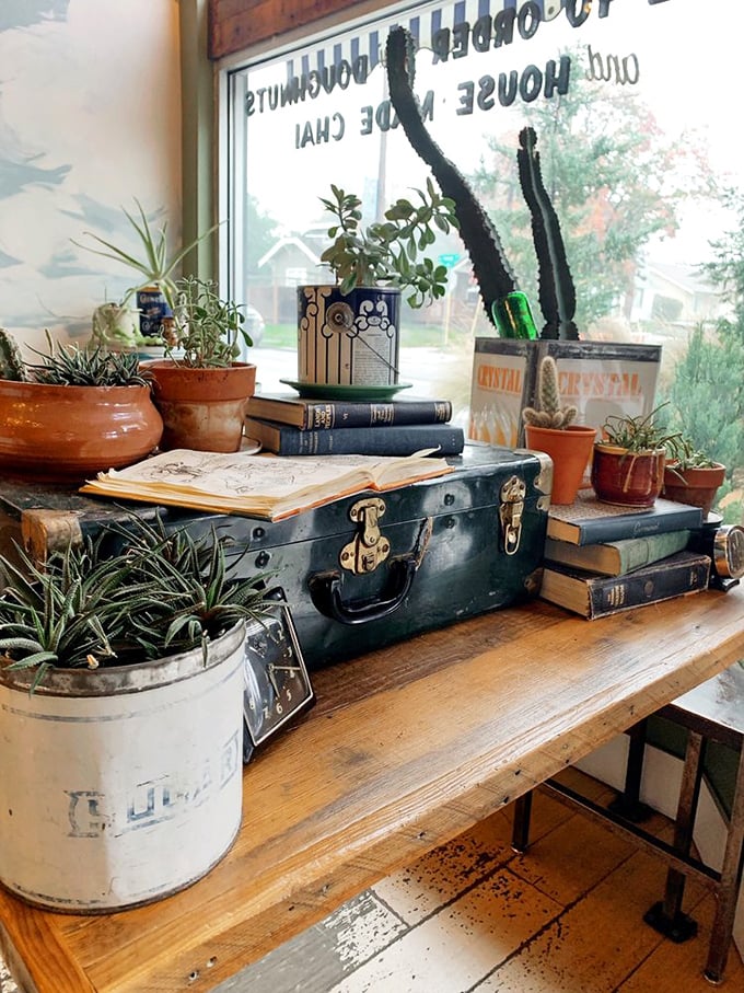 Vintage books, potted plants, and eclectic treasures create the feeling you're enjoying breakfast in the home of your coolest, most talented friend.