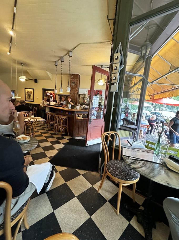 That checkered floor leads your eye to the bar, but your stomach knows the real destination is whatever's on those plates.