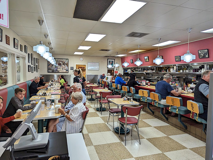 Where strangers share counter space and coffee refills flow like conversation. The checkered floor isn't just design&mdash;it's a chessboard where breakfast is always the winner.