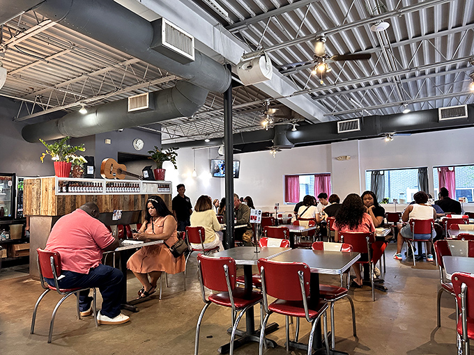 Red chairs and retro vibes create the perfect breakfast backdrop. The diverse crowd proves that excellent food is the ultimate unifier.