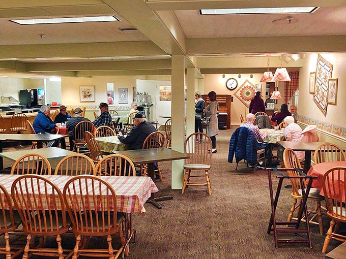 The dining area combines Windsor chairs and checked tablecloths in a room that feels less like a restaurant and more like the home of that relative who really knows how to cook.