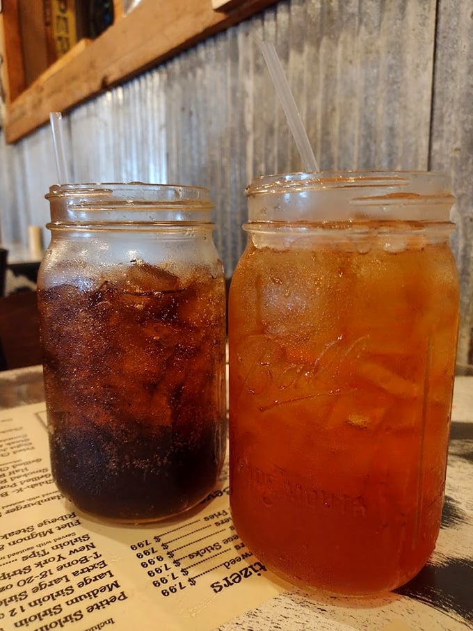 Mason jar drinks aren't just trendy here—they're practical vessels for delivering sweet tea and soda in quantities that say "stay awhile, friend."