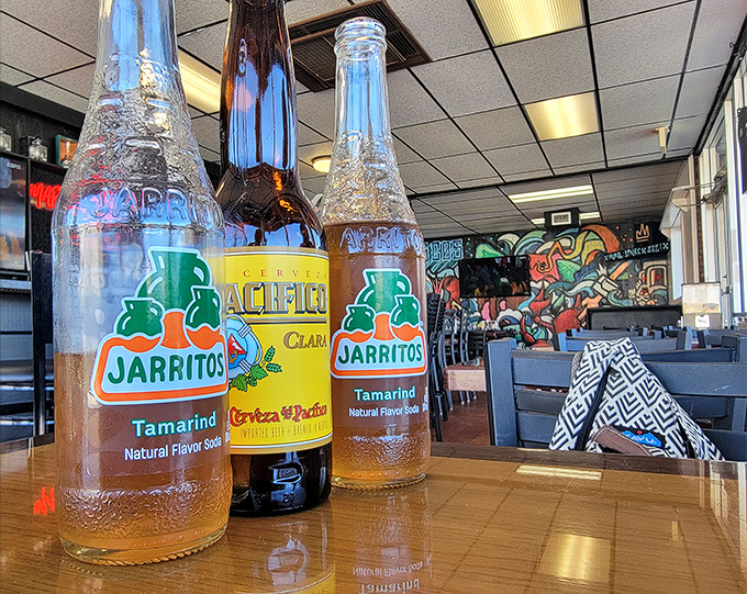 Mexican sodas and beers standing at attention like colorful soldiers. These traditional beverages are the perfect companions for your seafood adventure.