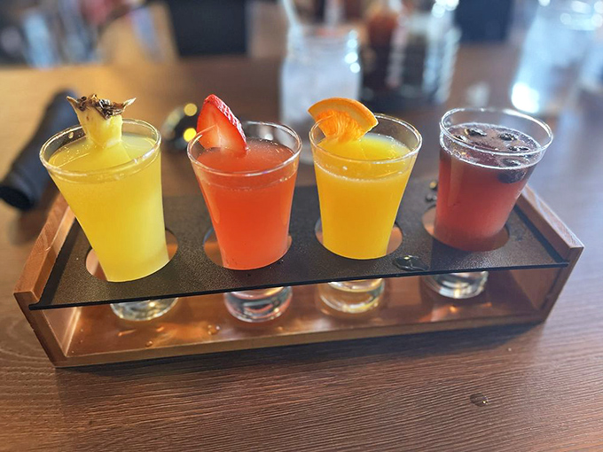 Four colorful mimosas lined up like liquid sunshine in glasses&mdash;weekend brunch's version of "choose your own adventure" in beverage form.