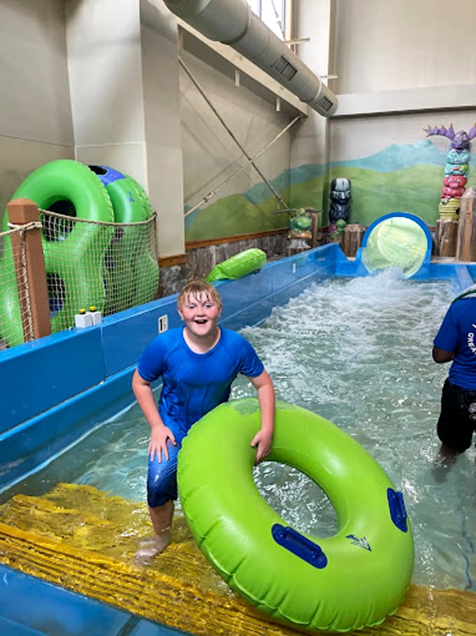 The universal language of childhood joy &ndash; one green inner tube, endless possibilities, and that look that says "I could do this literally all day."