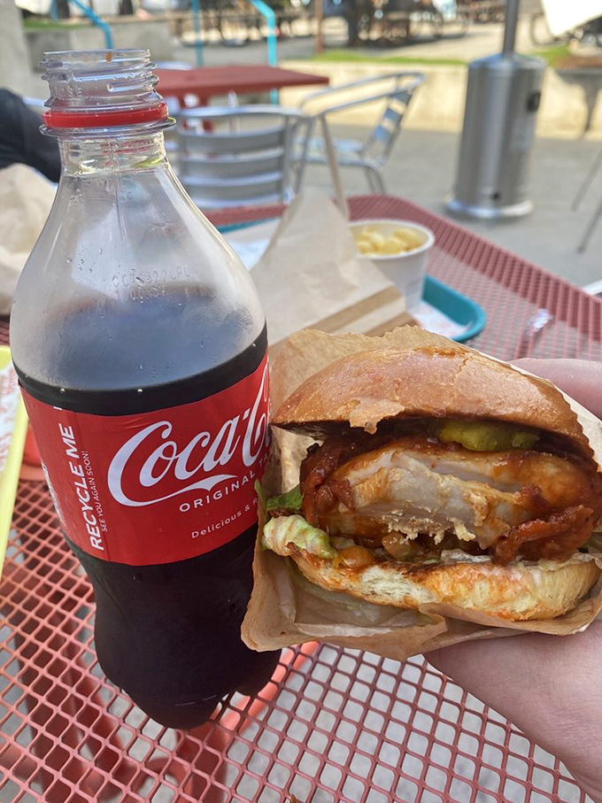 Al fresco dining with a sandwich that demands your complete focus. Notice how even the Coca-Cola label is turned toward it.