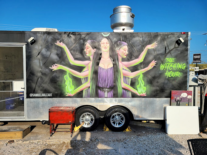 The truck's artwork serves as a culinary bat signal to horror fans and foodies alike &ndash; those glowing green hands promising flavors that are supernatural.