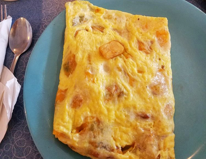 An omelet so perfectly executed it makes you wonder if there's a breakfast artist hiding in the kitchen, painting with eggs and fillings.