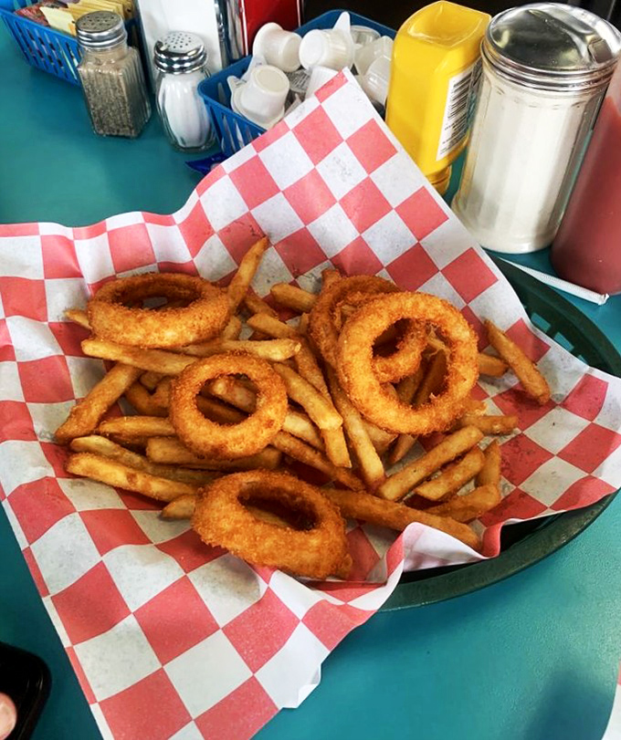 Golden onion rings and crispy fries arrive in a red-checkered basket&mdash;the universal signal that you're about to experience deep-fried bliss. Diet starts tomorrow.