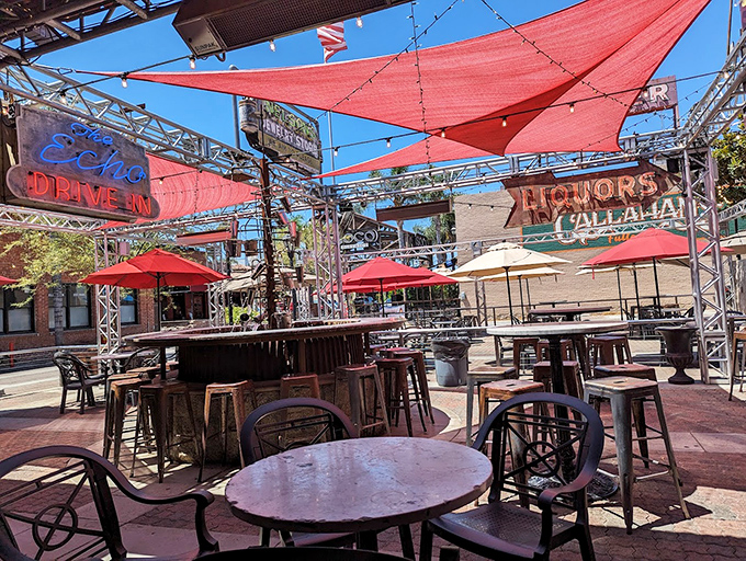 The outdoor seating area isn't just a patio&mdash;it's an urban oasis. Those red canopies create the perfect microclimate for serious sandwich consumption.