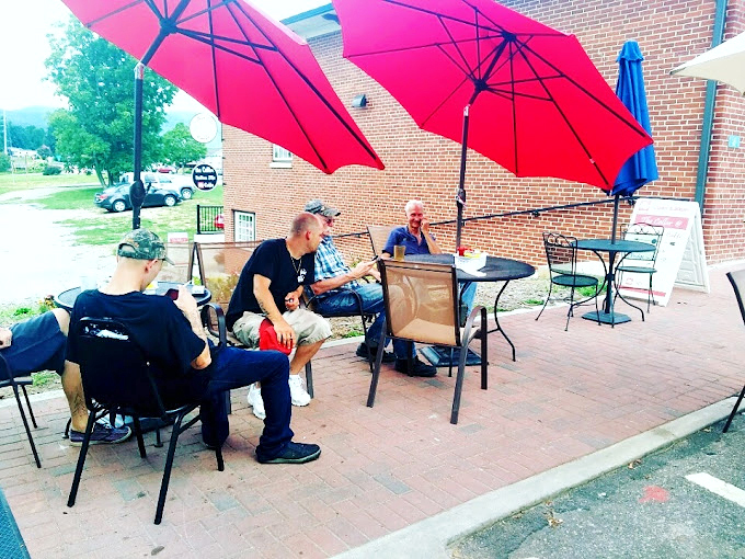 Under bright red umbrellas, locals gather to solve the world's problems over coffee&mdash;the unofficial morning meeting spot of Blairsville's finest minds.