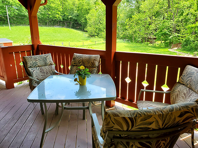 The porch seating arrangement practically whispers, "Your morning coffee deserves a better view than your kitchen sink."