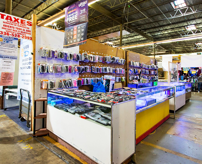 Today's technology meets yesterday's pricing at booths where smartphone accessories shine under displays that promise deals.