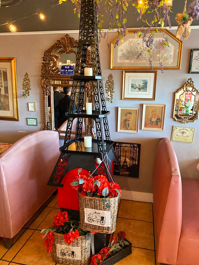 A miniature Eiffel Tower surrounded by flowers and framed by pink banquettes&mdash;because sometimes the most charming French touches are the least subtle ones.