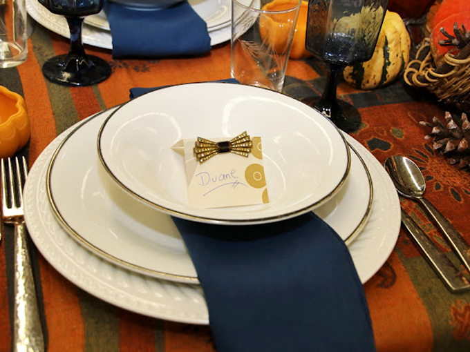 Elegant place settings that once hosted family dinners now wait for new tables to grace, complete with tiny bow ties for your napkins.