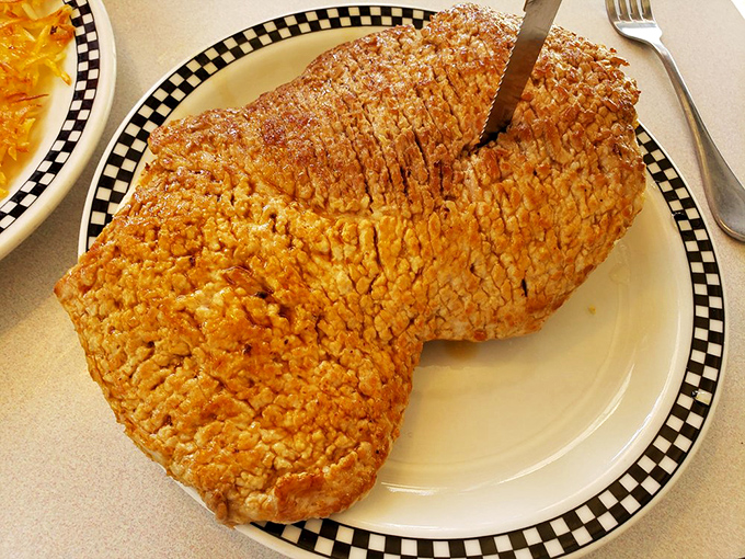 The breaded pork tenderloin&mdash;an Indiana institution&mdash;spills magnificently over the plate's edges. This sandwich requires both hands and commitment.