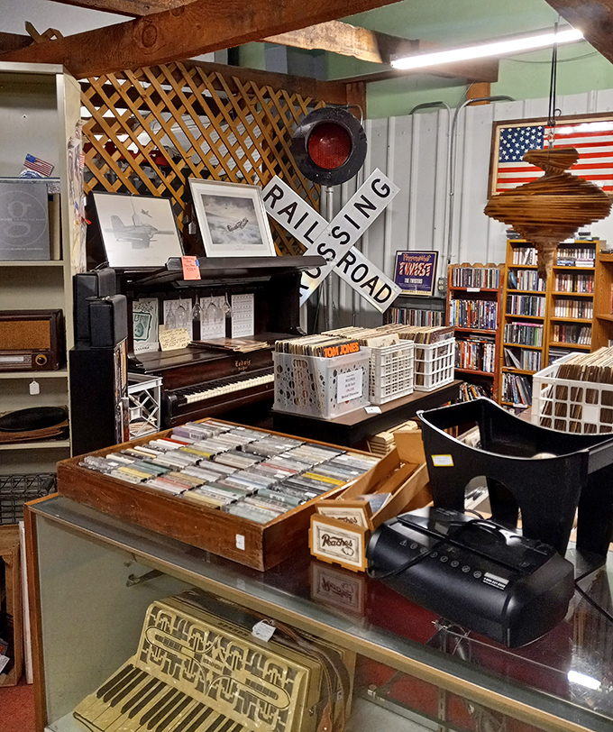 A vinyl lover's treasure chest beside a piano that's played countless family sing-alongs. That railroad crossing sign warns: danger of spending hours browsing ahead!