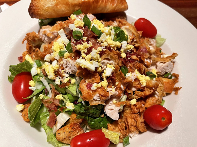 This isn't just a salad&mdash;it's a protein-packed festival where chicken, bacon, and egg hold a summit meeting on crisp lettuce.