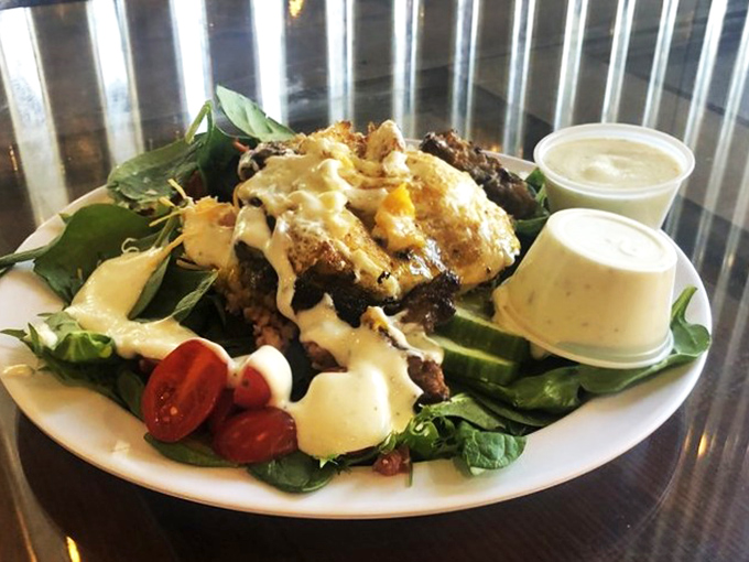 A burger patty that decided to go swimming in a sea of greens. Proof that salads don't have to be punishment&mdash;they can be celebration.