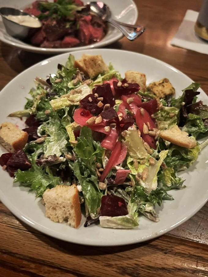 The outdoor patio with its cheerful red umbrellas offers a breath of fresh air while maintaining Clyde's signature hospitality. 