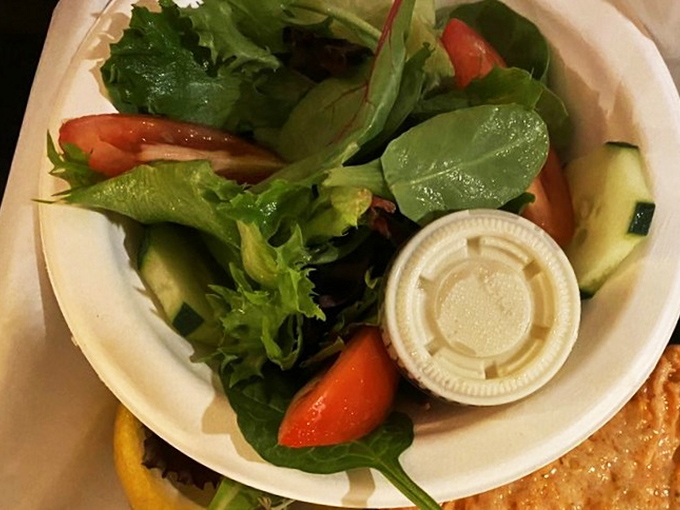 Even the garden salad gets the coastal treatment. Fresh greens and vegetables provide a crisp counterpoint to seafood indulgences—balance in all things, even feast days.