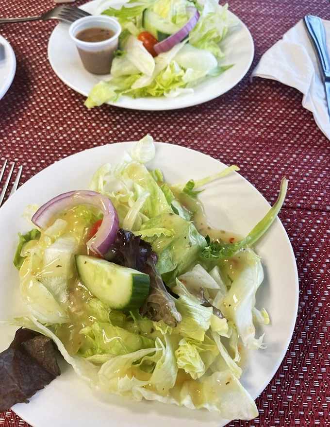 The house salad—a crisp, refreshing interlude that politely suggests you might consider eating something green between pasta courses.