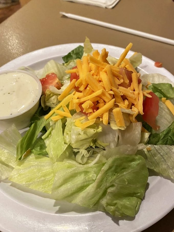 A house salad that actually deserves the name "salad" rather than "obligation to vegetables." That shredded cheddar adds a touch of Americana.