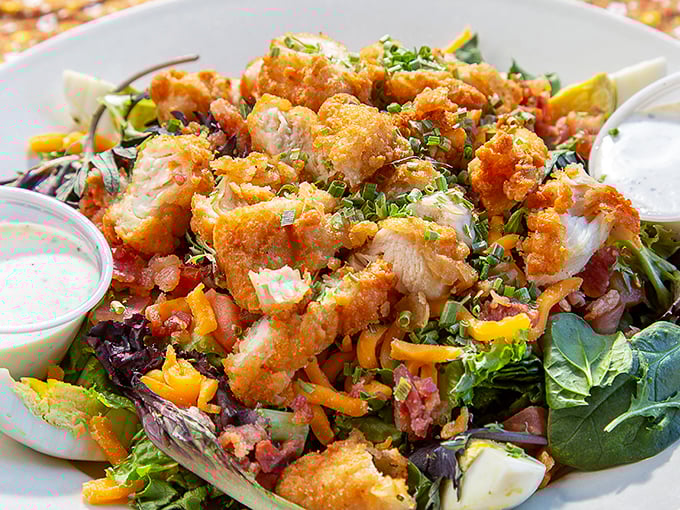 A salad that's having an identity crisis as a feast. Those crispy chicken pieces are the confetti at this lettuce party.