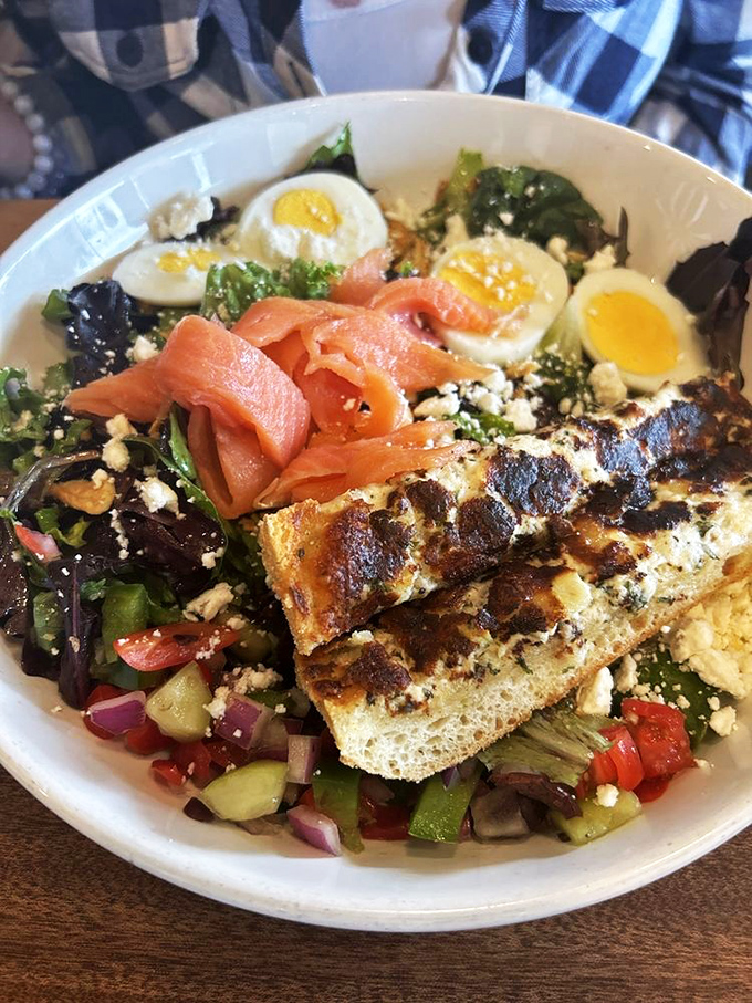 A salad that's trying to convince you it's health food despite the generous portions of smoked salmon and feta. The crispy bread adds textural contrast to this beautiful arrangement.