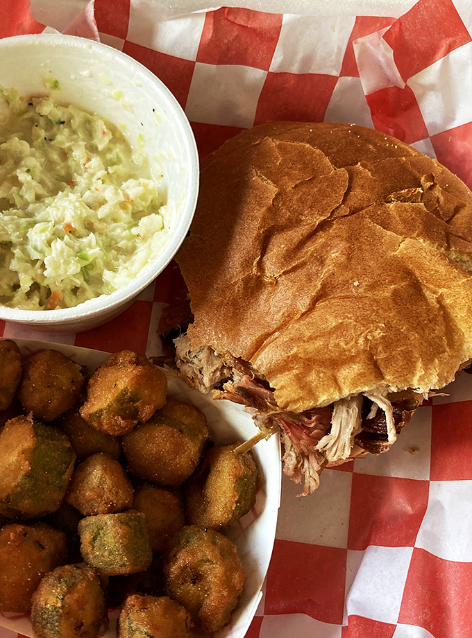 The pulled pork sandwich, coleslaw, and fried green tomatoes&mdash;a holy trinity of Southern comfort that makes you question why you'd eat anything else.