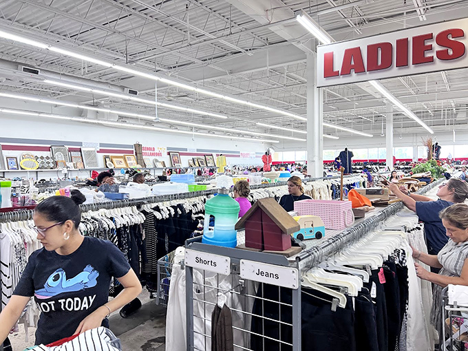 Organized chaos at its finest &ndash; racks labeled with helpful signs guide shoppers through the fashion forest where "PANTS" and "SHORTS" await new legs. 
