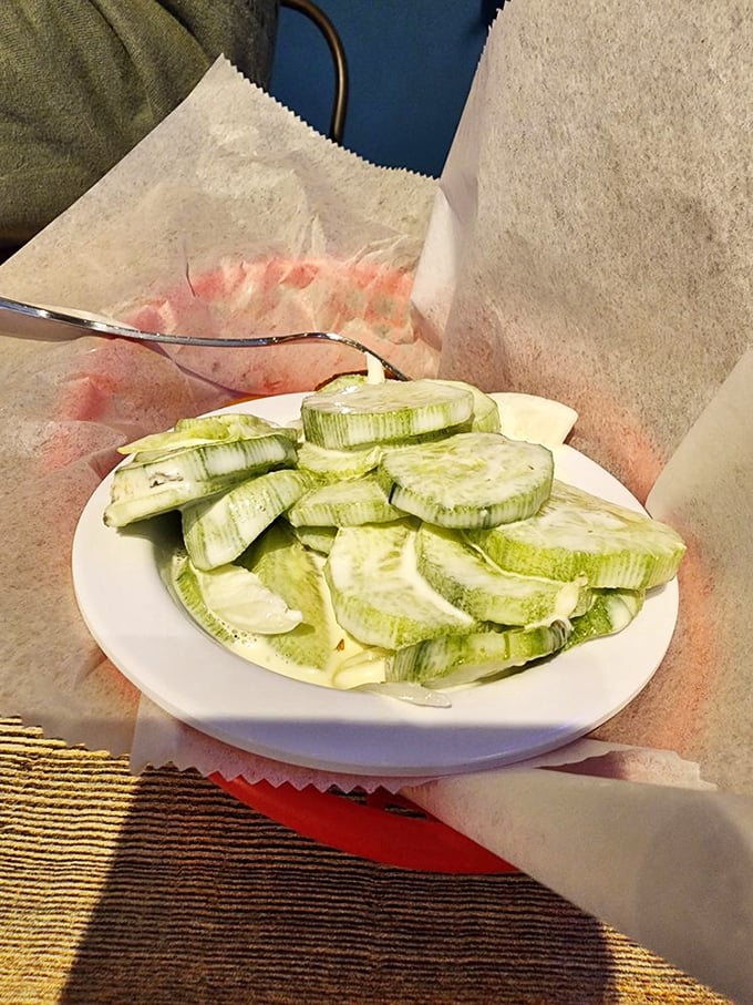 Fresh-sliced cucumbers offer a crisp, palate-cleansing counterpoint to rich seafood&mdash;simple side dishes that prove Mother Shuckers understands balance.