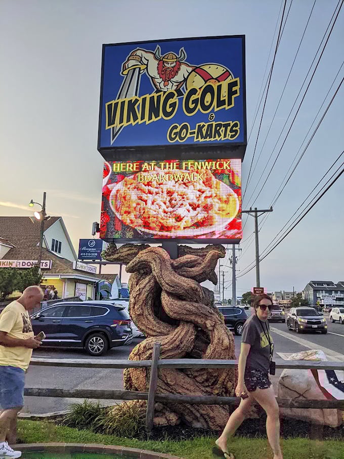 The roadside sign stands as a beacon of fun, promising adventures that beat scrolling through your phone for the 87th time today.
