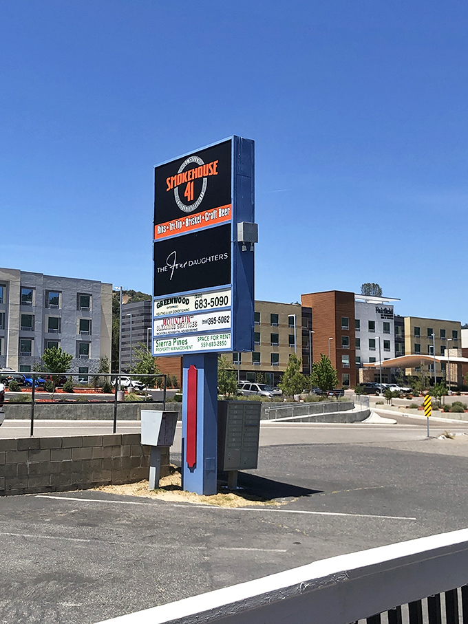 The roadside sign stands tall against the California sky, a barbecue lighthouse guiding hungry travelers to their smoky destination.