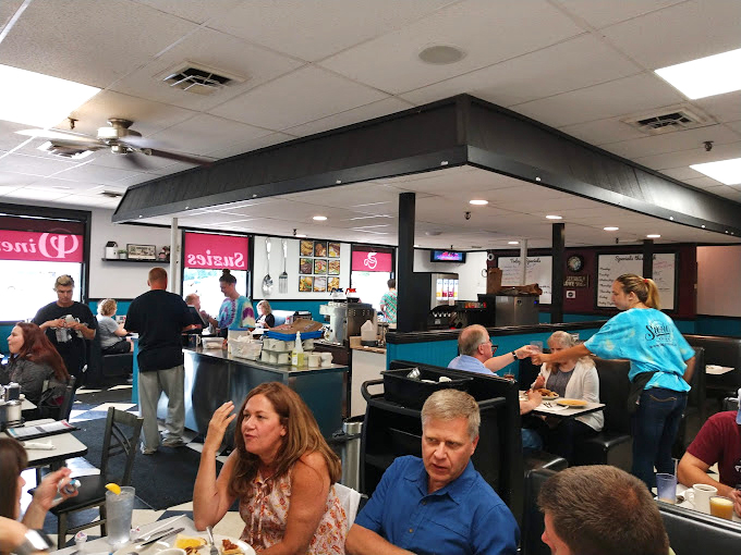 Controlled breakfast chaos where servers navigate their domain with the precision of air traffic controllers and twice the personality.