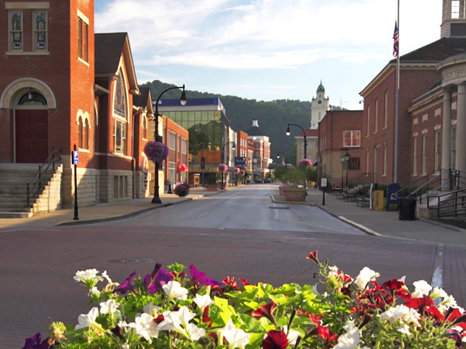 Morning light bathes empty streets in golden possibility, while hanging flower baskets add splashes of color to Pikeville's architectural canvas.