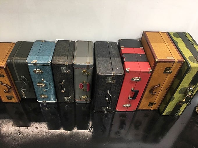 Vintage suitcases stand like colorful soldiers, each having carried someone's hopes and dreams to destinations unknown.