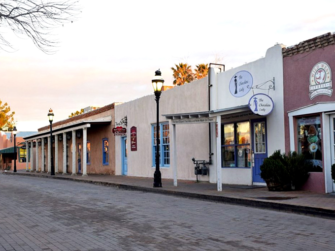 Sunset paints Mesilla's buildings in honey-gold light, transforming humble adobe into architectural caramel just before the desert stars appear.