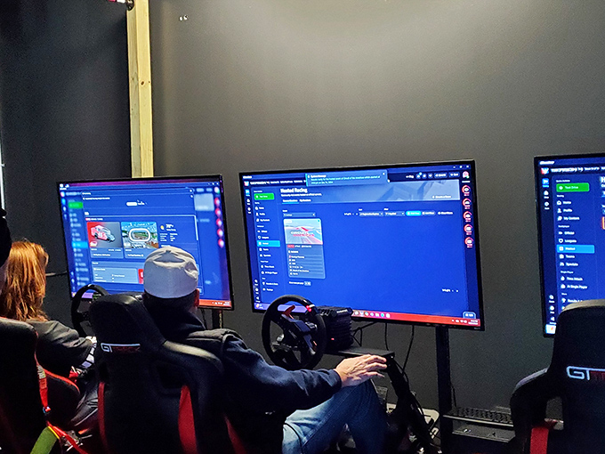 Virtual racing simulators—where digital practice makes for perfect real-world cornering. The serious expressions say it all.