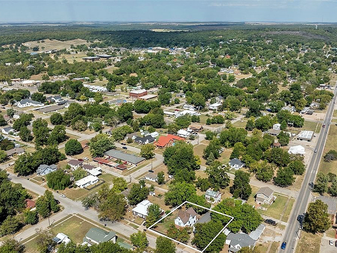 From above, Pawhuska reveals itself as an oasis of green, where homes nestle among trees and the prairie stretches beyond the horizon.