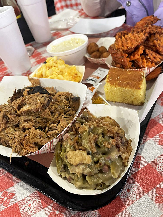 This spread isn't a meal&mdash;it's a family reunion where every dish is the favorite cousin. That cornbread square isn't just a side; it's the golden ticket to barbecue nirvana.