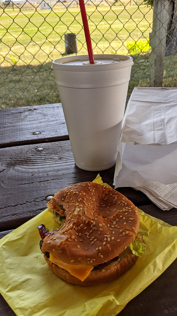The perfect roadside companion: a juicy cheeseburger with all the fixings and a shake to wash it down.