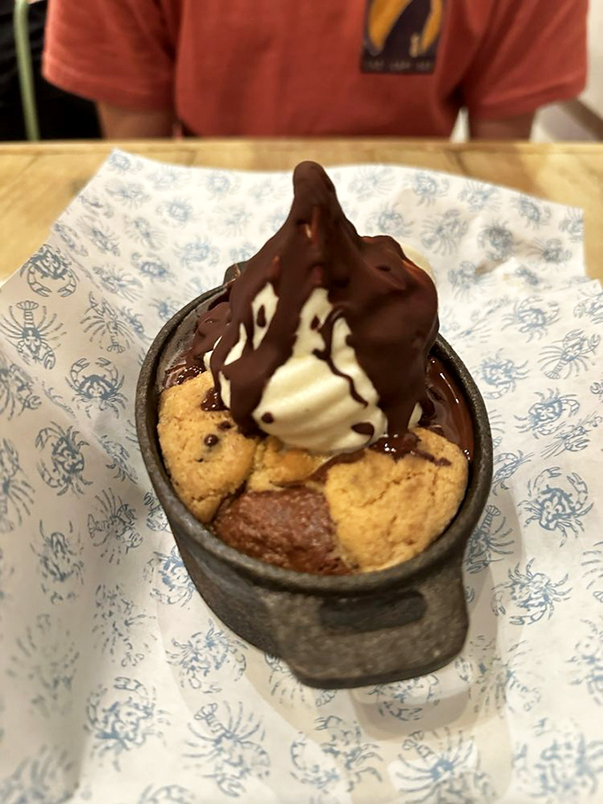 Sweet finale: a warm cookie-brownie hybrid topped with ice cream and chocolate, because even seafood feasts deserve a standing ovation at the end.