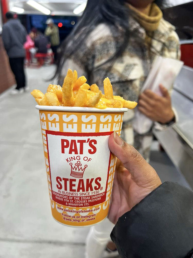 Cheese fries: the perfect sidekick to any cheesesteak adventure. That cup design hasn't changed in decades&mdash;because perfection needs no update.
