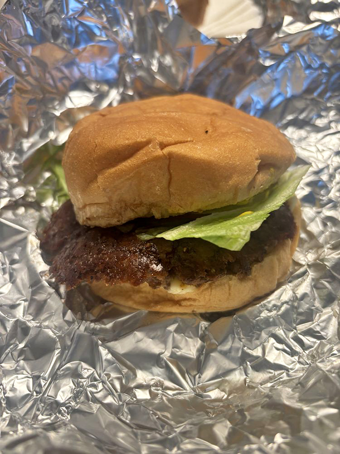 The simple cheeseburger, perfected&mdash;fresh lettuce peeking out like it knows it's part of something greater than the sum of its humble parts.