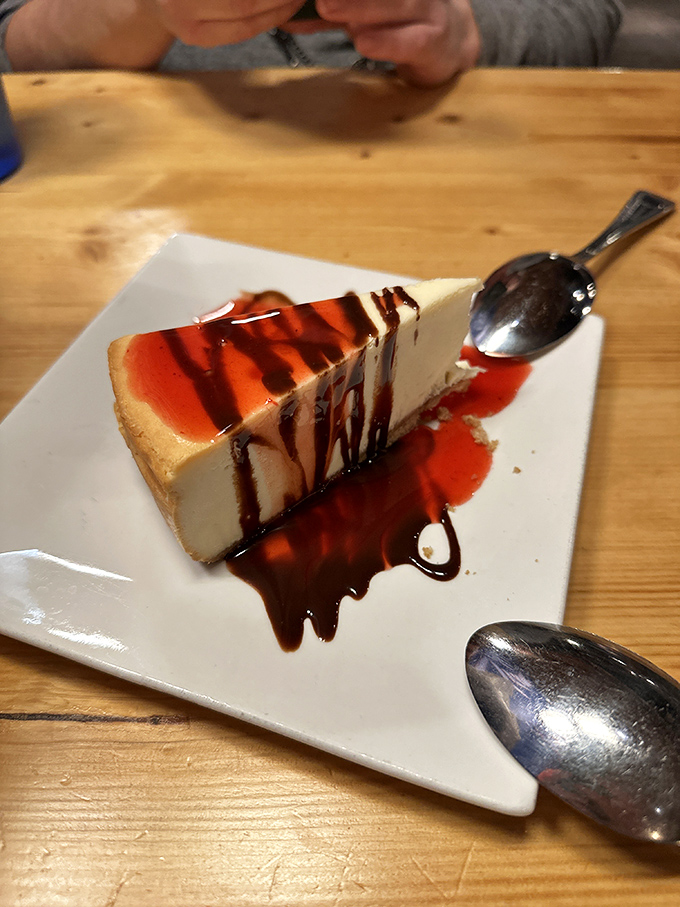 Cheesecake with a sauce drizzle that performs the perfect balancing act between "I shouldn't" and "just one more bite."