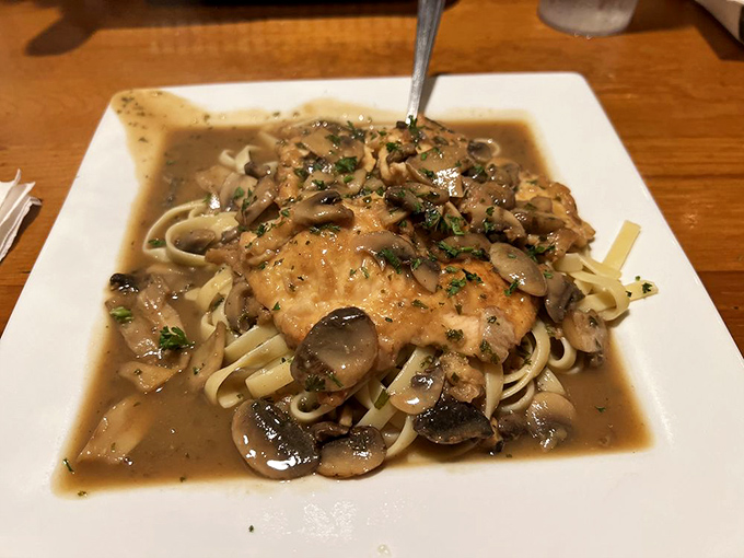 Chicken Marsala swimming in mushroom wine sauce&mdash;proof that sometimes the best vacation for your taste buds is just a short drive away.