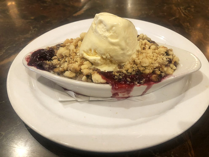 The perfect ending to any meal – warm fruit cobbler topped with vanilla ice cream that's melting just enough to create rivers of sweetness throughout.