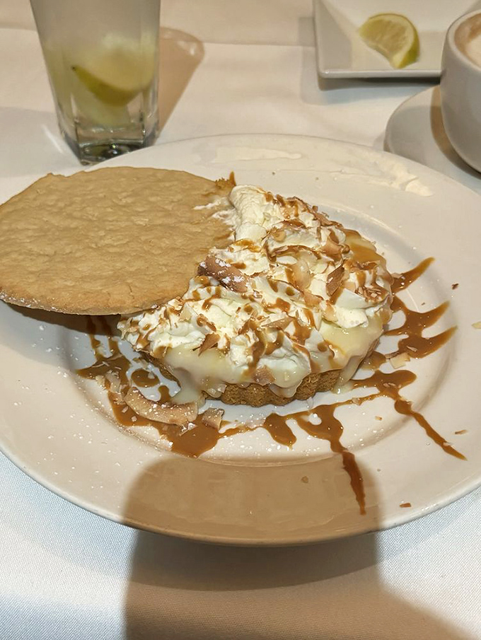 This isn't just dessert &ndash; it's architecture with a purpose. The golden cookie crown commands respect before surrendering to your spoon. 